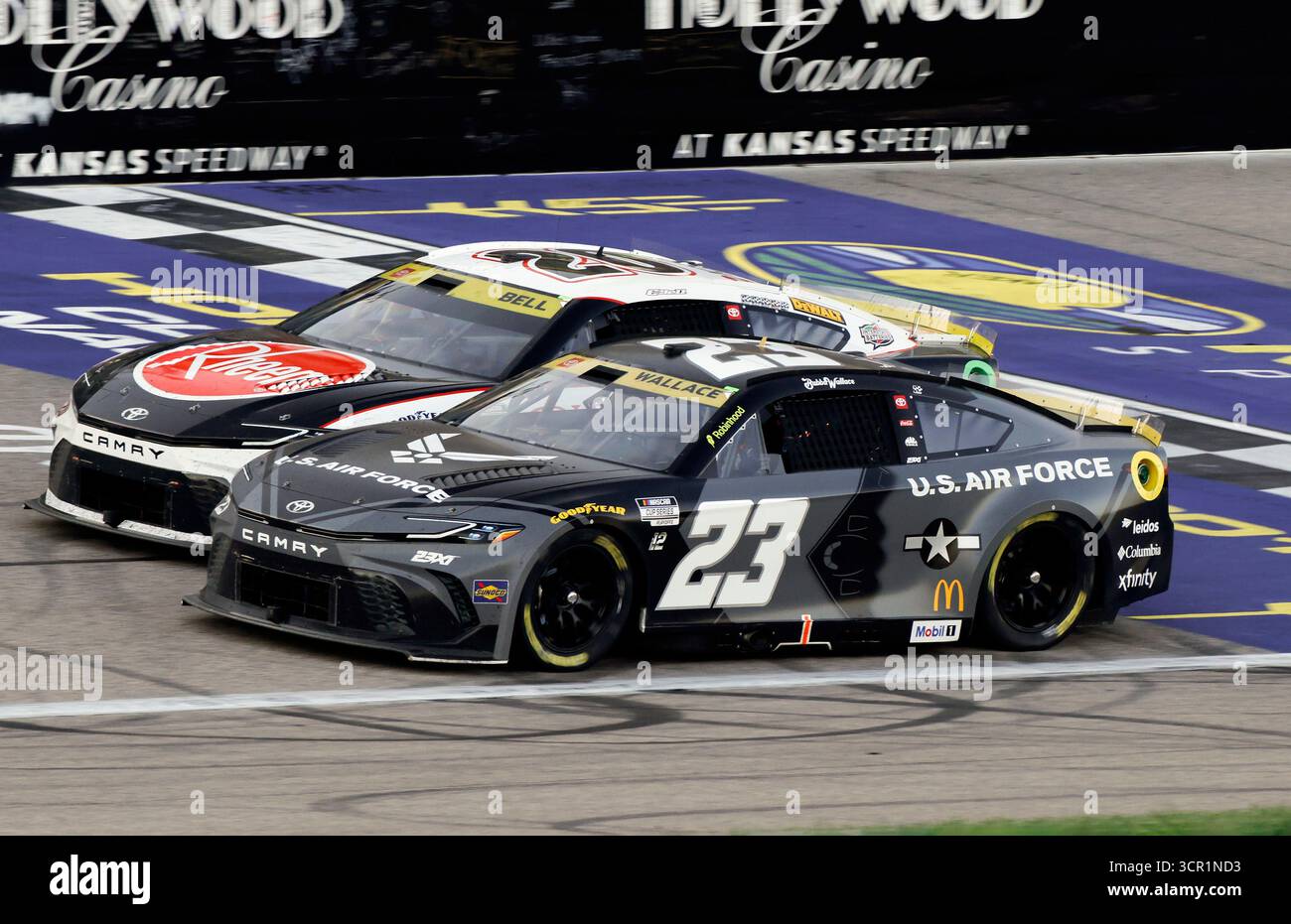 Christopher Bell (20) and Bubba Wallace (23) race side-by-side after a ...