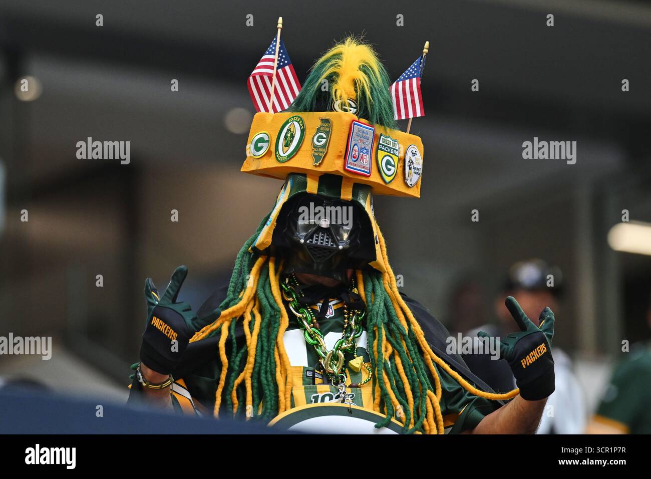 A Green Bay Packers fan dressed in costume poses for a photo as they ...