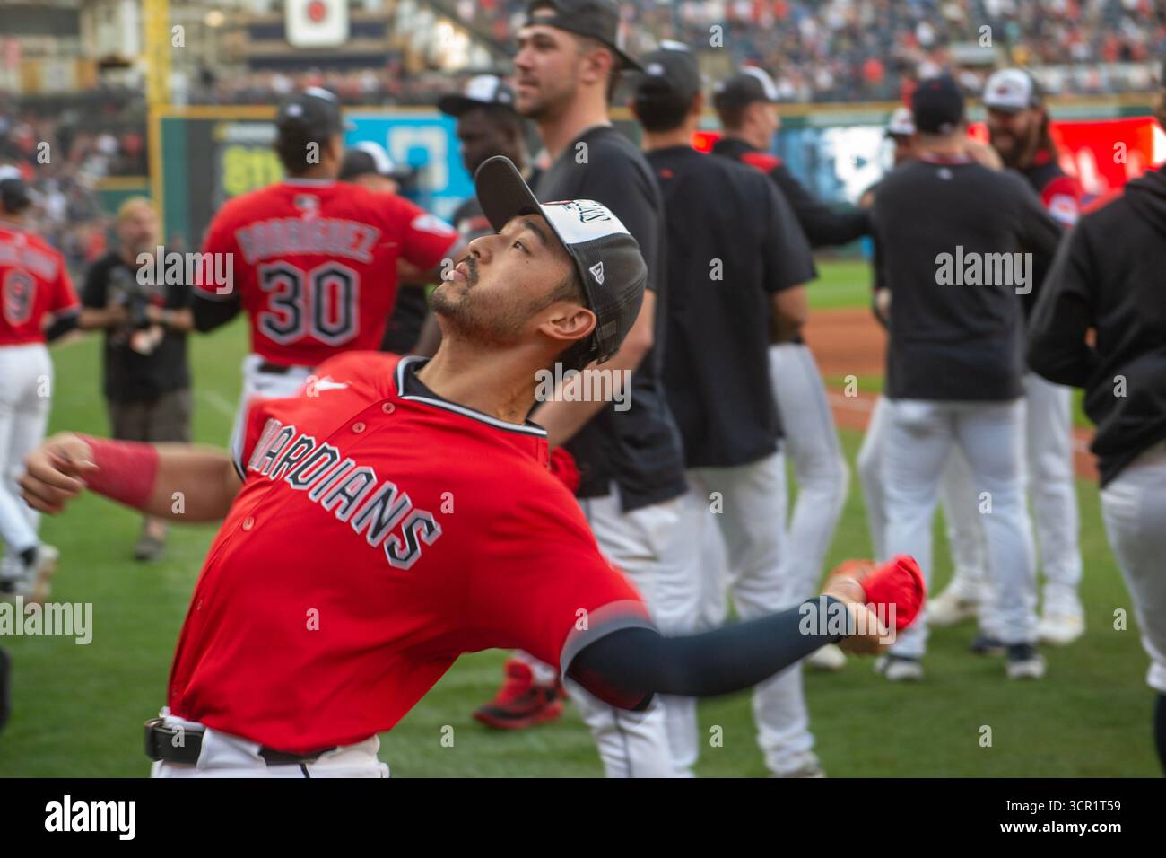 Cleveland Guardians' Steven Kwan throws T-shirts to the crowd as the ...