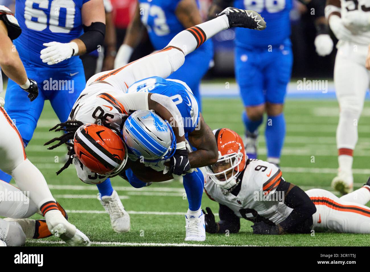Detroit Lions running back Jahmyr Gibbs (0) is tackled by Cleveland Browns linebacker Devin Bush ...