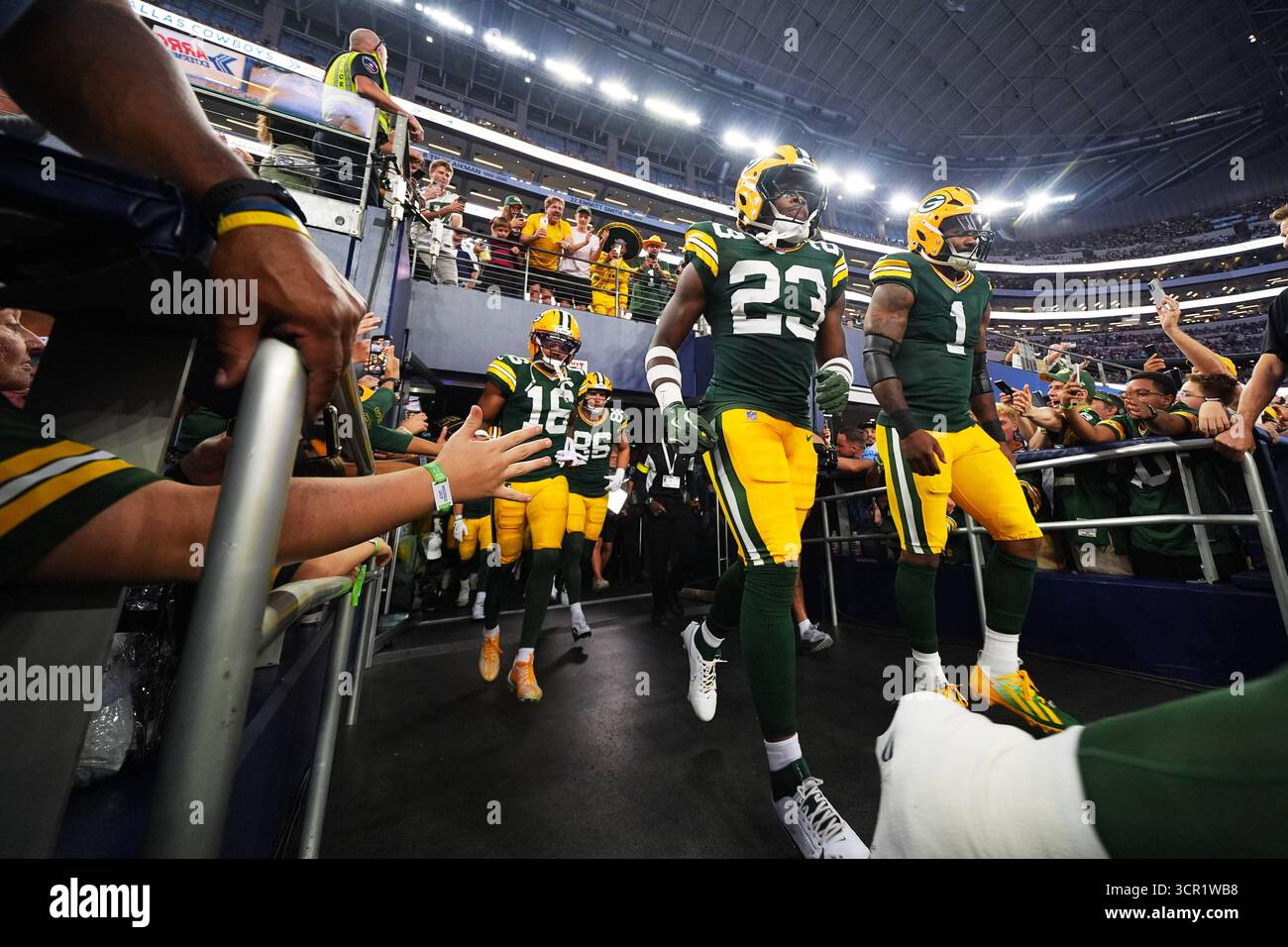 Green Bay Packers' Emanuel Wilson (23) and Micah Parsons (1) jog out ...
