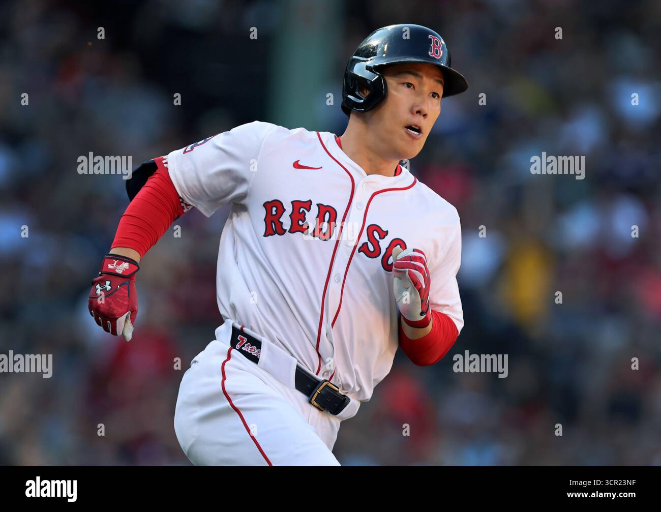 Boston Red Sox's Masataka Yoshida sprints down the first base line as he watches his first ...
