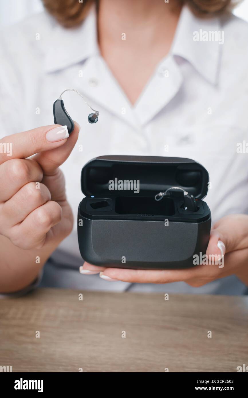 Patient charging hearing aid hi-res stock photography and images - Alamy