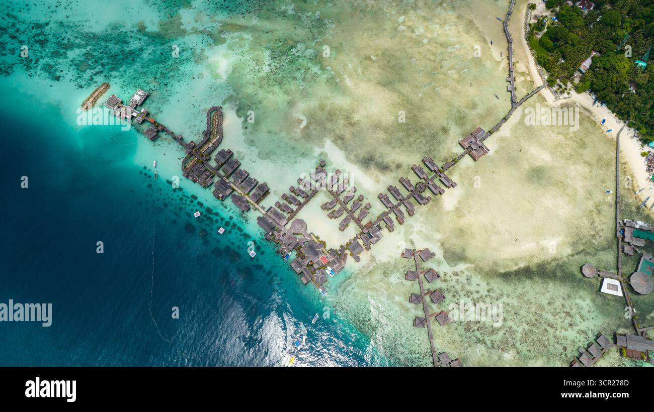 Aerial drone of tropical island Mabul in the blue sea with a coral reef ...