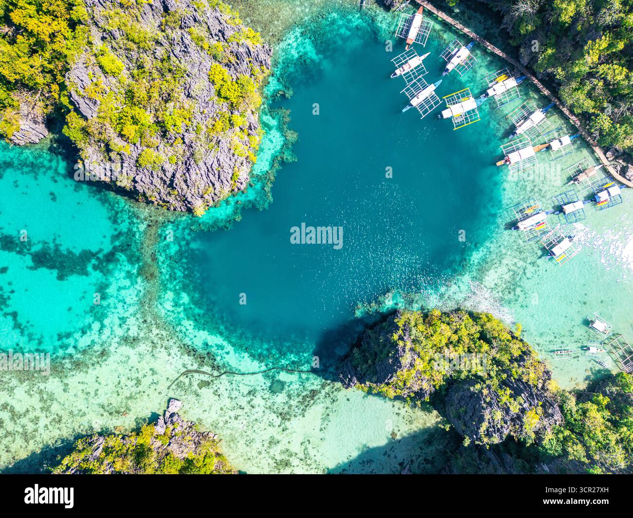 Aerial view of twin lagoon surrounded by limestone cliffs and turquoise ...