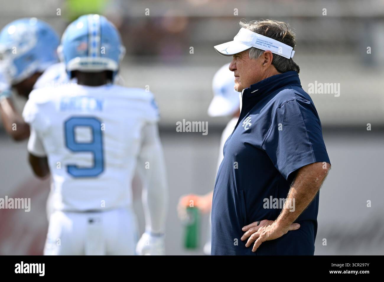 North Carolina head coach Bill Belichick looks on as players warm up ...