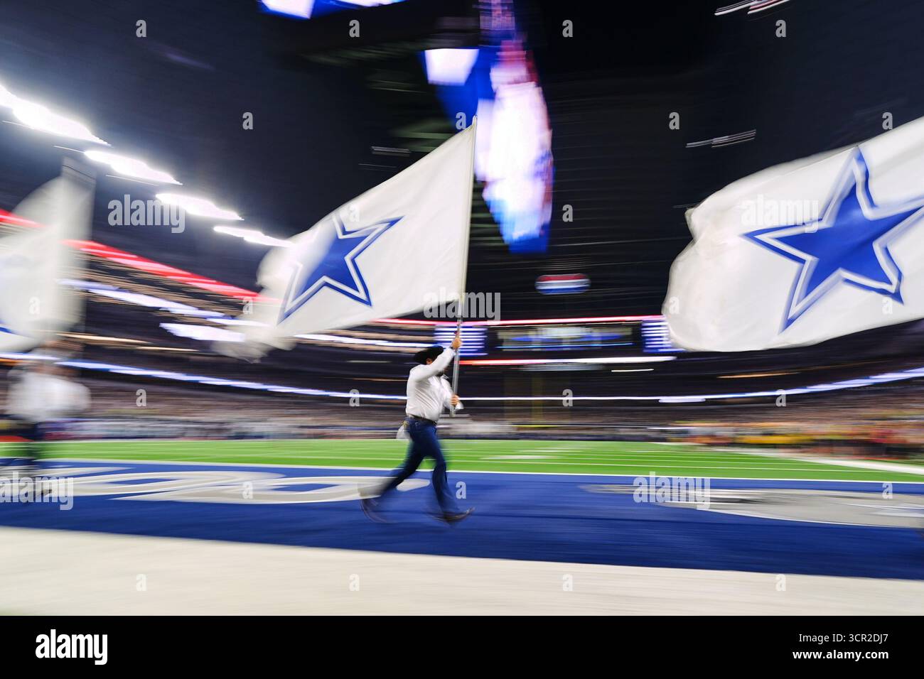 The Dallas Cowboys flag runners celebrate a touchdown in the first half ...