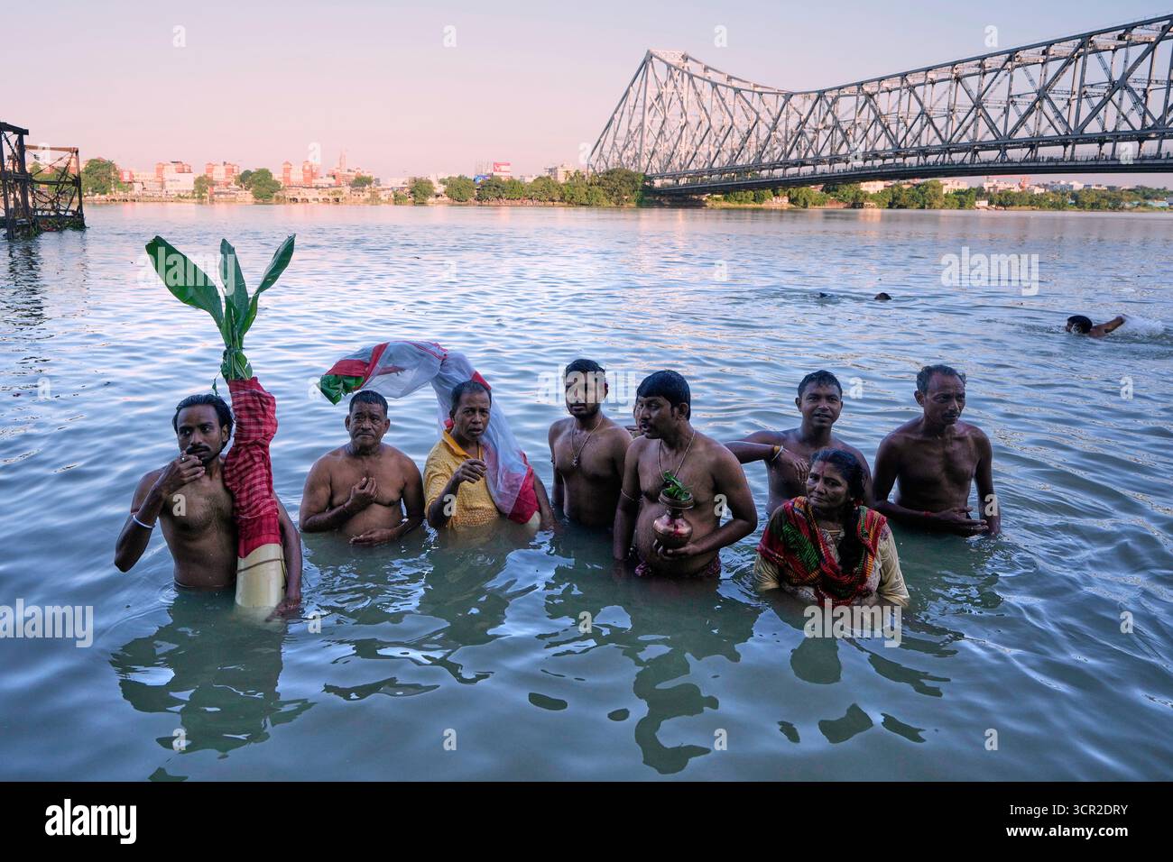 Hindu devotees take a bath with a banana tree near the iconic Howrah ...