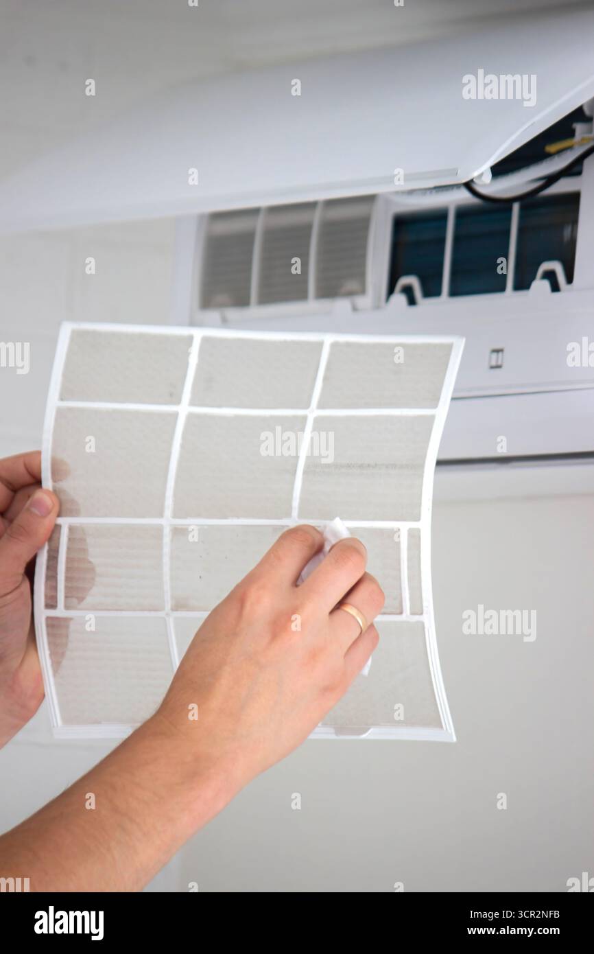 Air Conditioner Maintenance: Removing a Dirty Air Filter Stock Photo ...