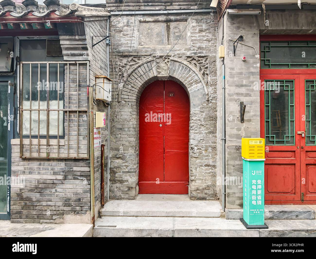 Beijing, China - September 15, 2025 : A striking red arched door stands ...