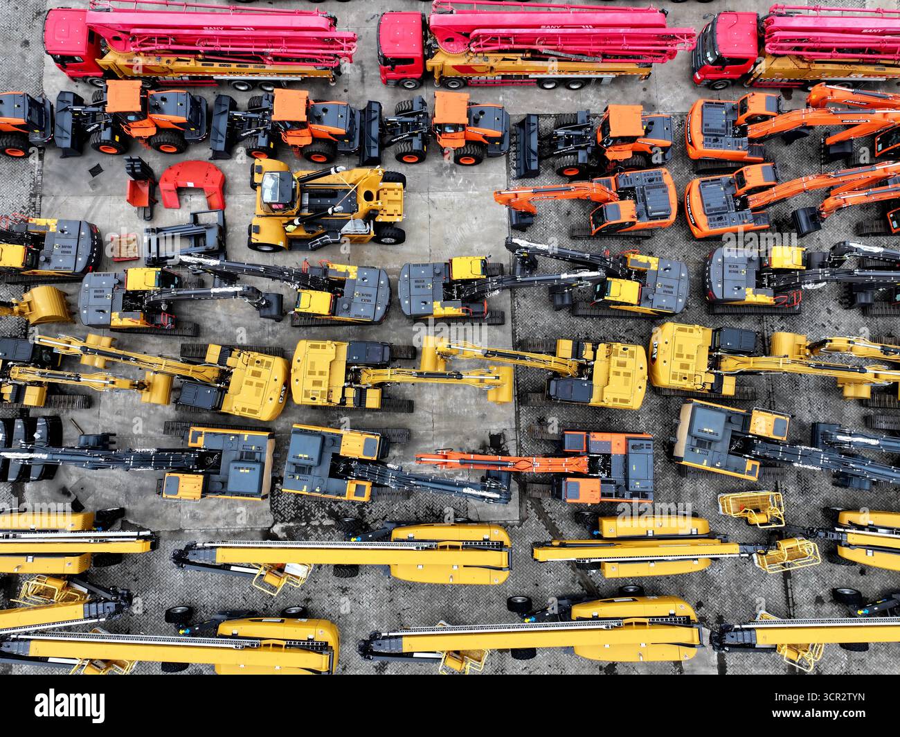 Aerial photo shows export-bound machineries and vehicles await loading ...