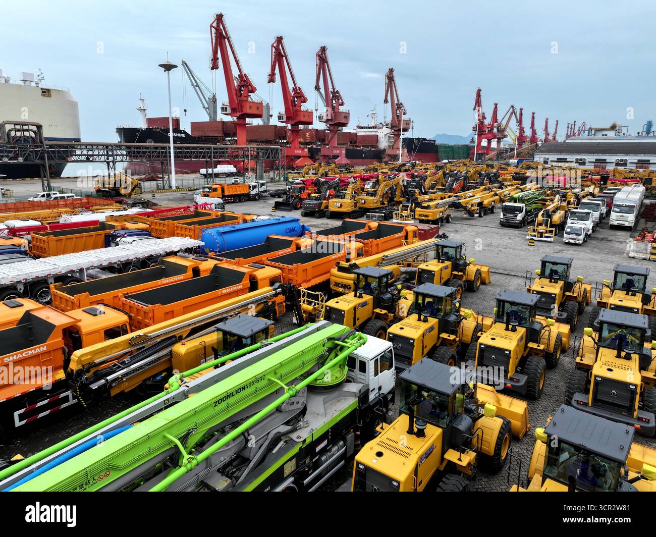 Aerial photo shows export-bound machineries and vehicles await loading ...