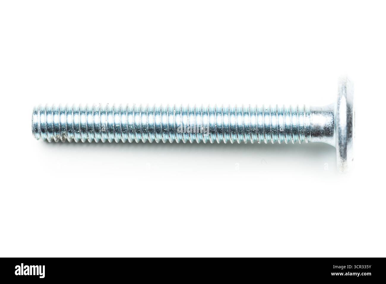 Metal screw with a flat head and threaded shaft on a neutral background ...