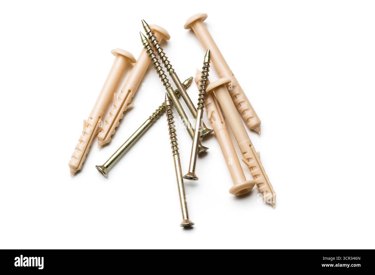 Assorted screws and wall anchors arranged on a white background for ...