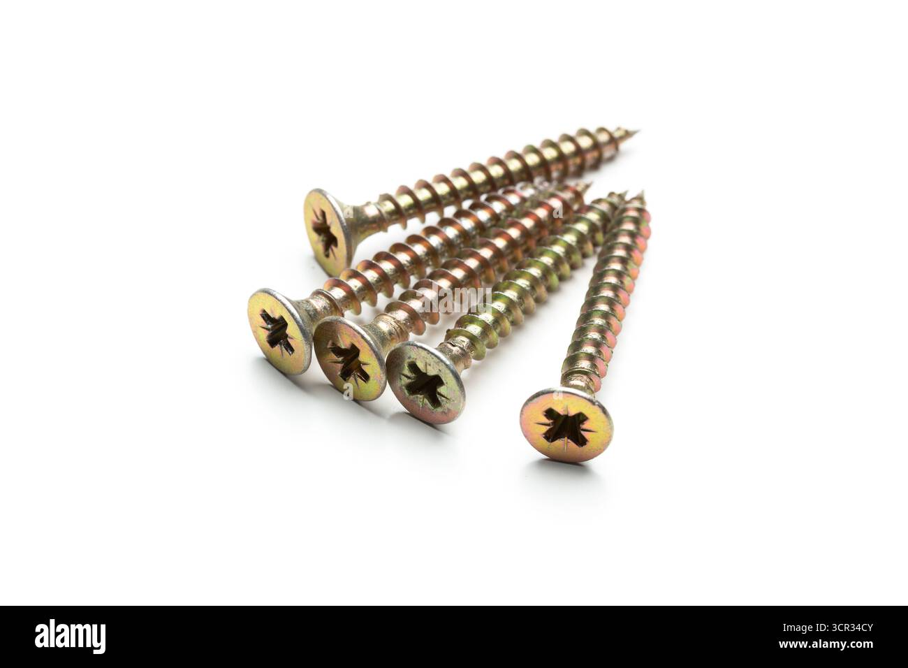 Close-up view of metal screws arranged in a group on a plain background ...
