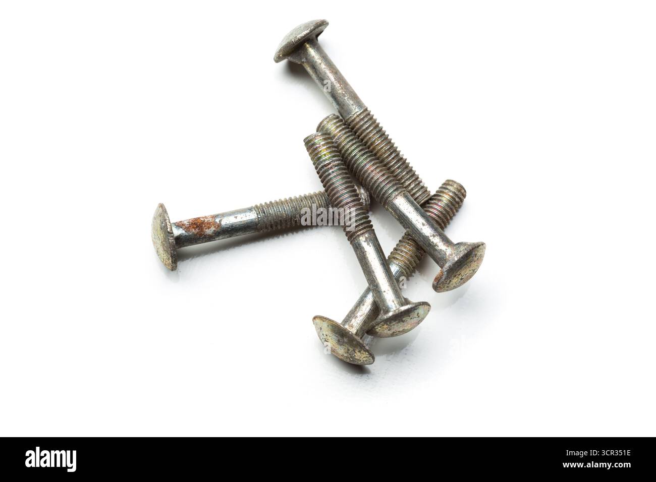 Collection of rusty screws piled together on a white background for ...