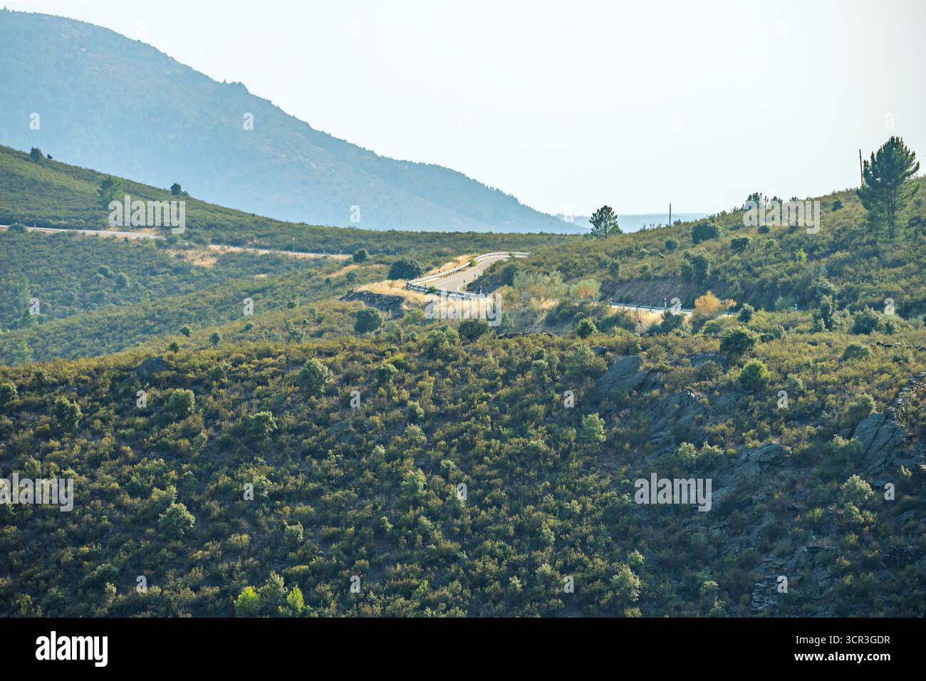 A scenic route with sweeping curves that skirts cliffs where sturdy ...