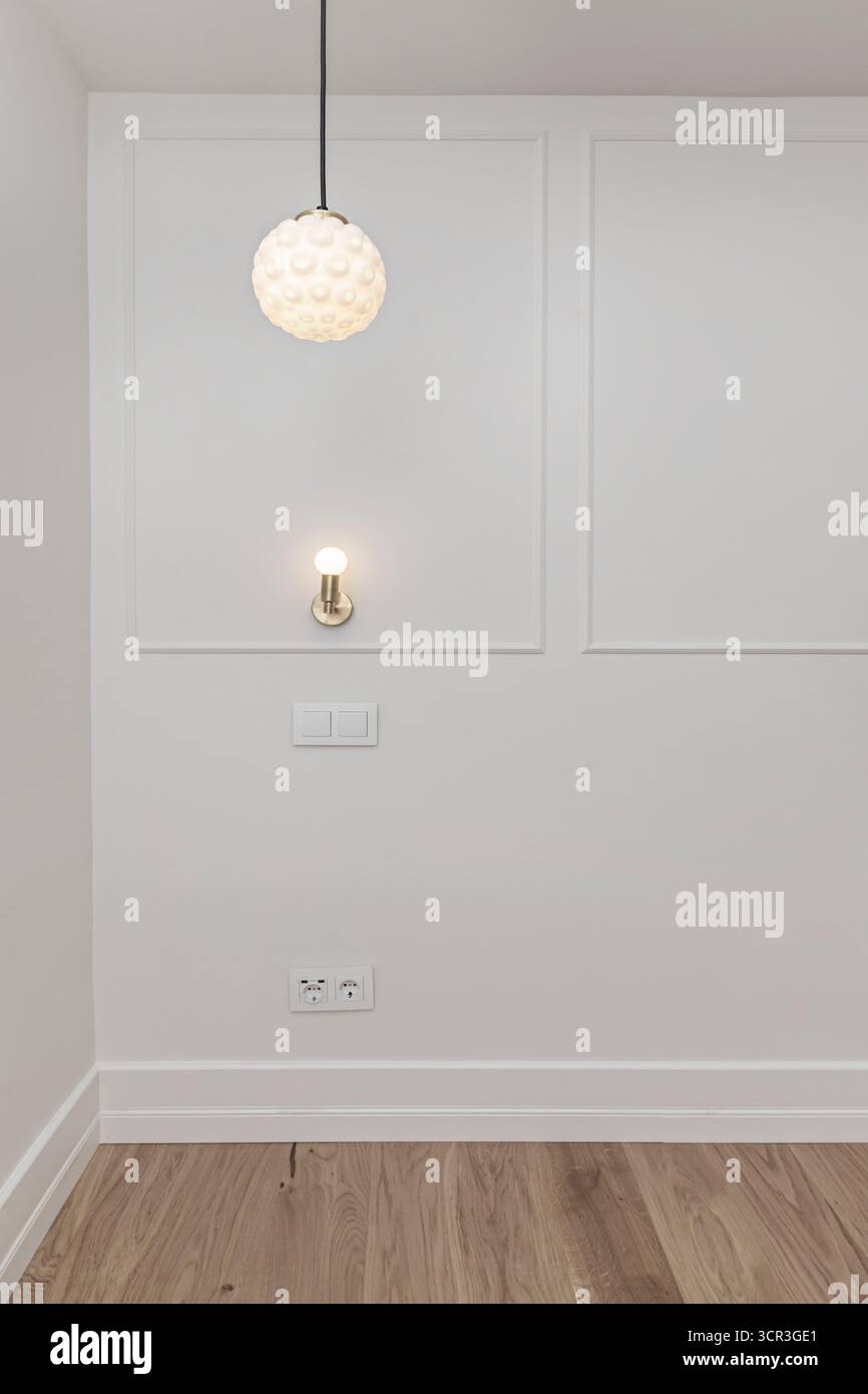 Hallway wall with circular disco recessed wall lights that evenly ...