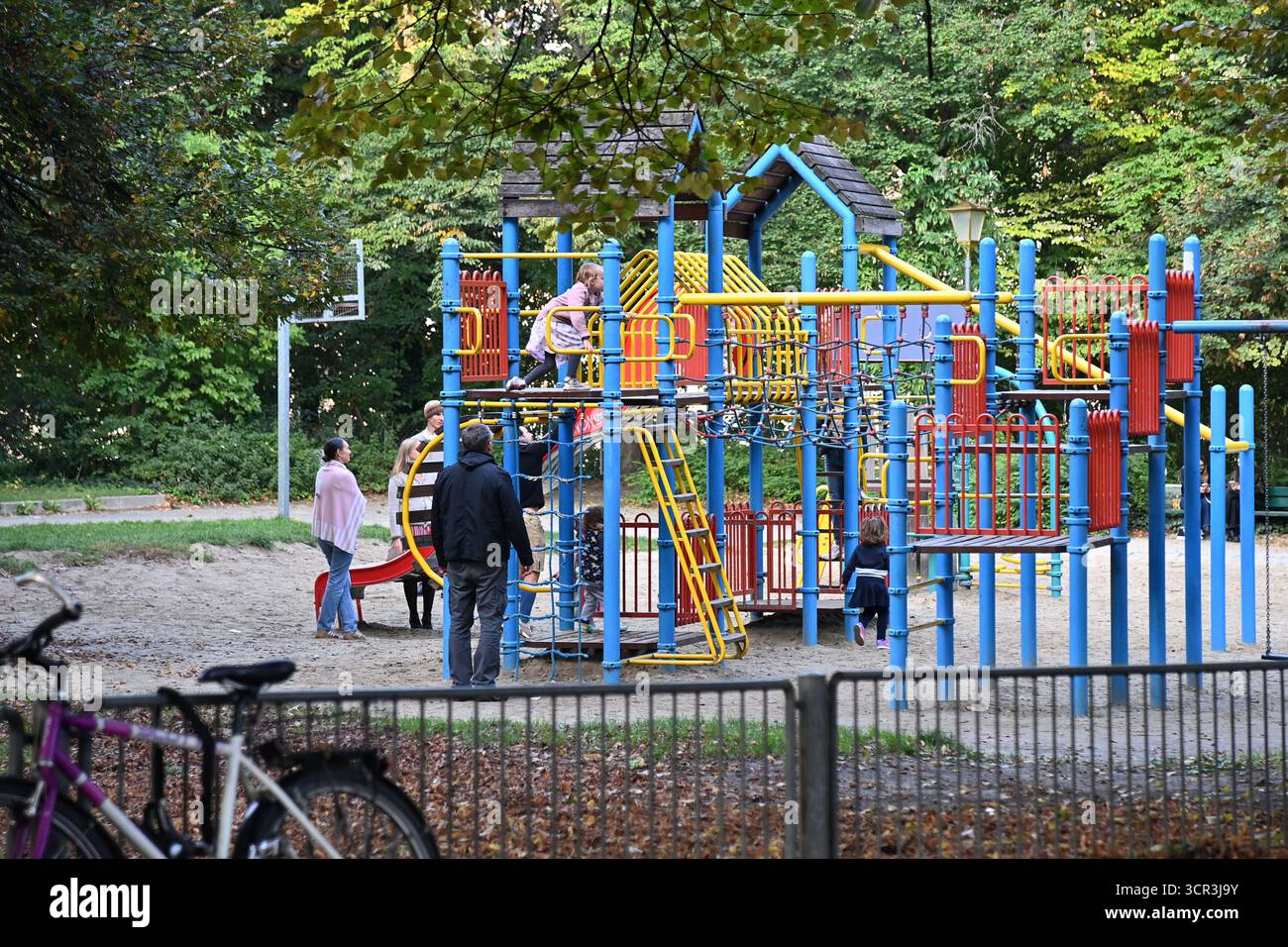 Playground in Munich: children playing on playground equipment, parents ...