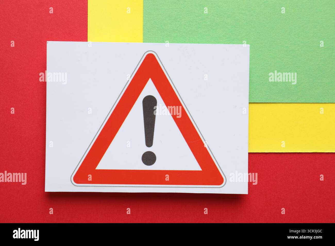 Risk. Sheet of paper with warning sign on color background, top view ...