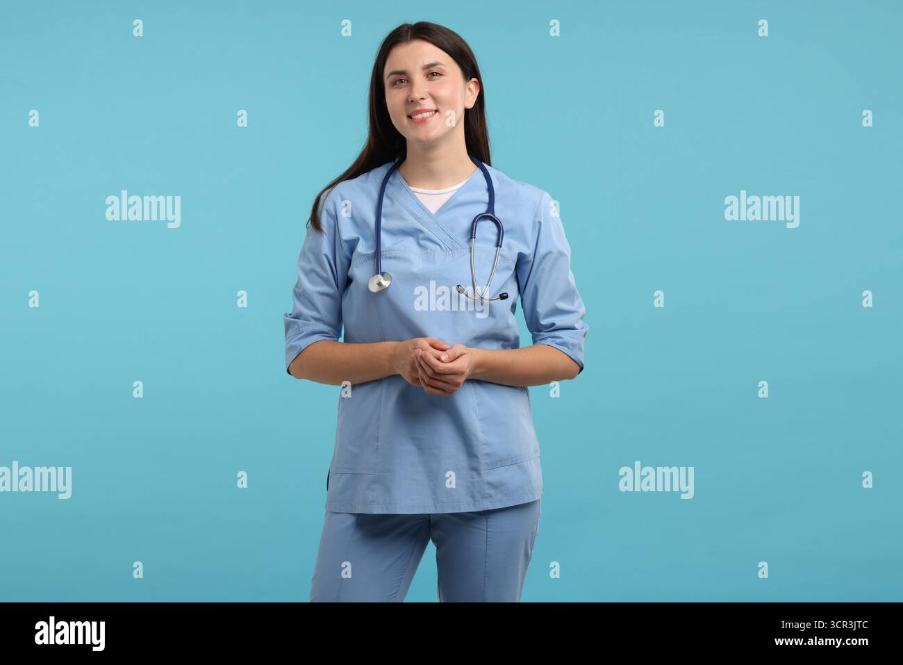 Nurse with stethoscope on light blue background Stock Photo - Alamy