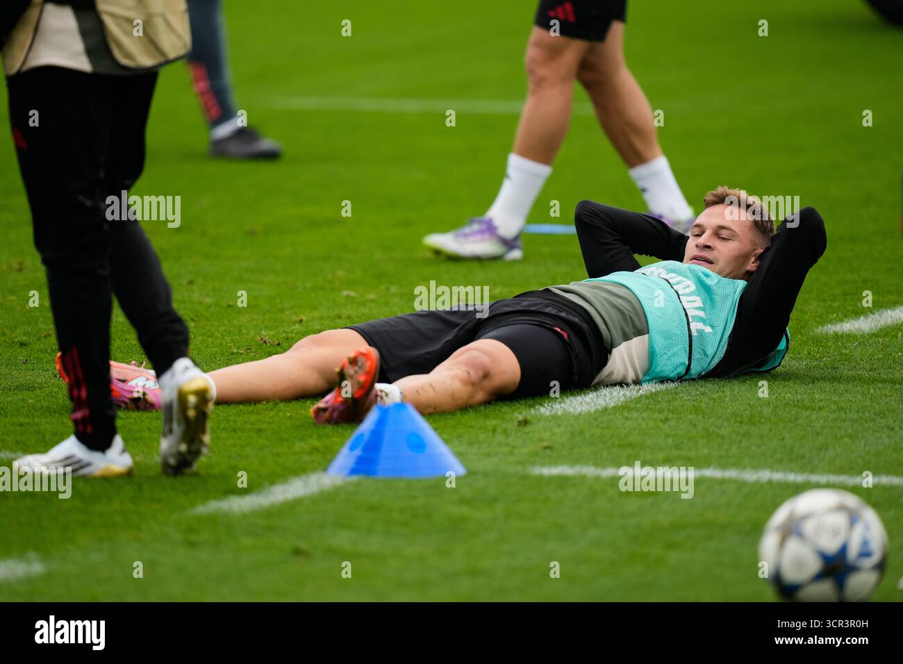 Bayern's Joshua Kimmich lies on the ground during a training session in ...