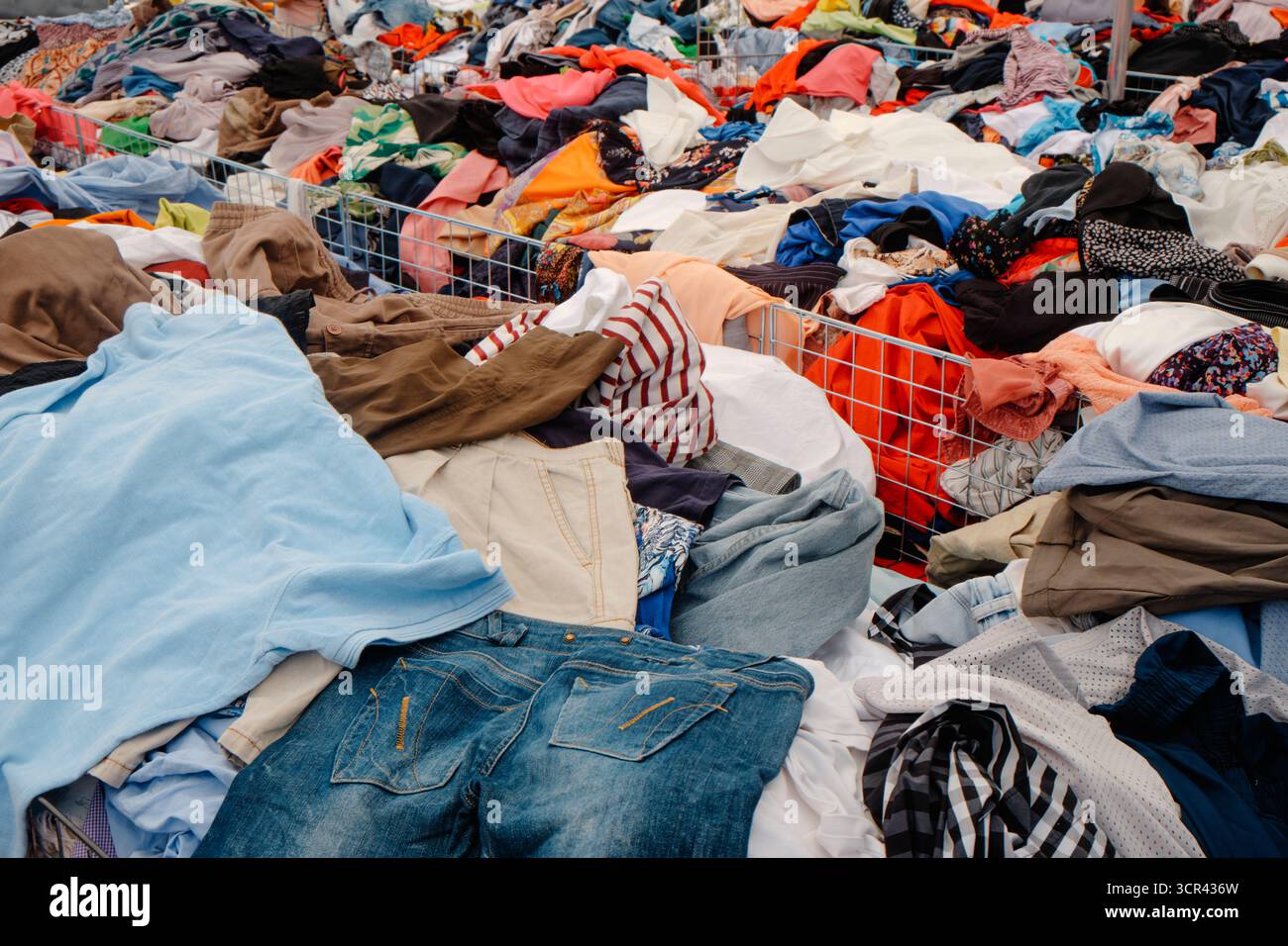 piles of clothes in assorted colors and fabrics are stacked inside ...