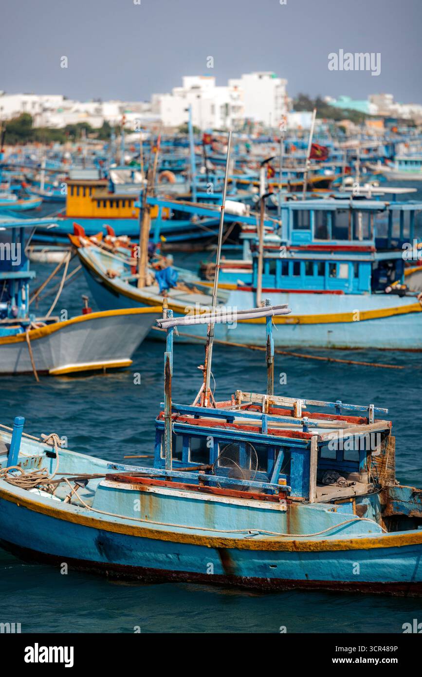 Numerous colorful fishing boats anchored in a bustling harbor with ...
