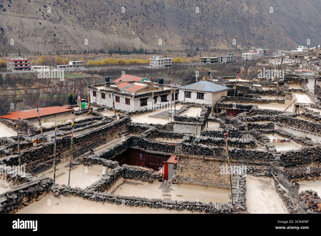 Stone-built village with terraced rooftops set against a mountainous ...