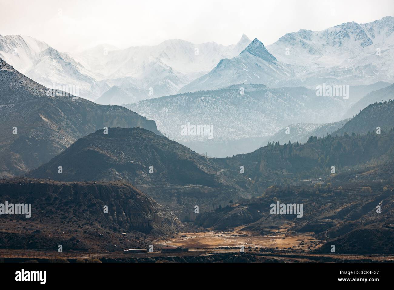 Majestic mountain range with snow-capped peaks and layered, rugged ...