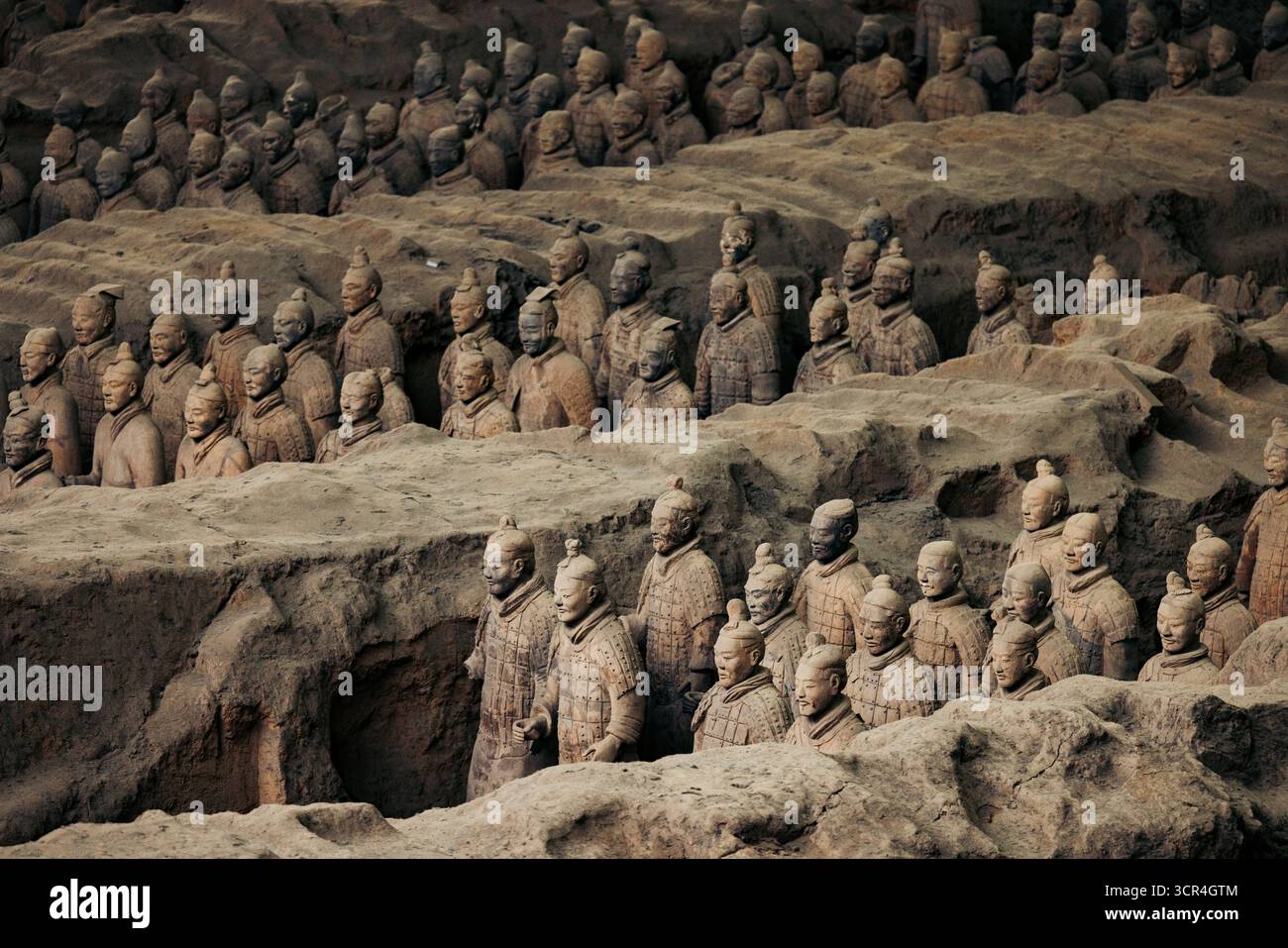 Rows of ancient Terracotta Army statues in an archaeological excavation ...