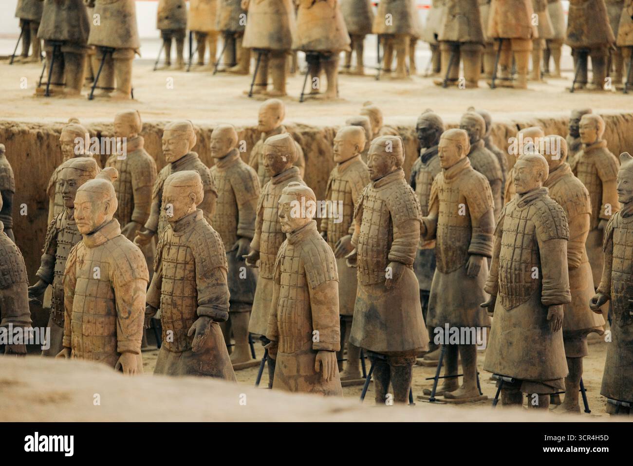 Rows of ancient terracotta warrior statues stand in archaeological site ...