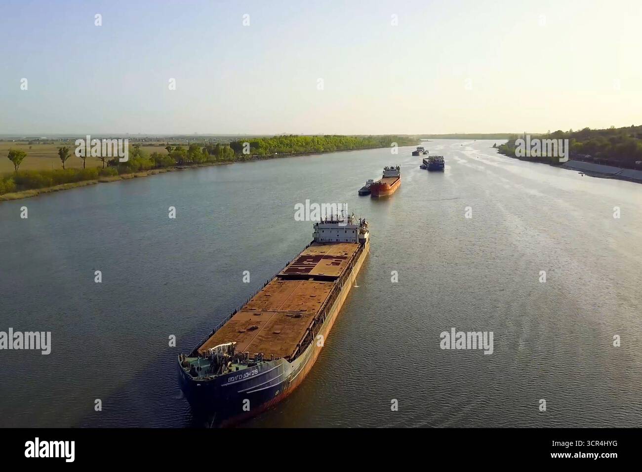 A cargo barge floats along the river. Cargo ship Stock Photo - Alamy