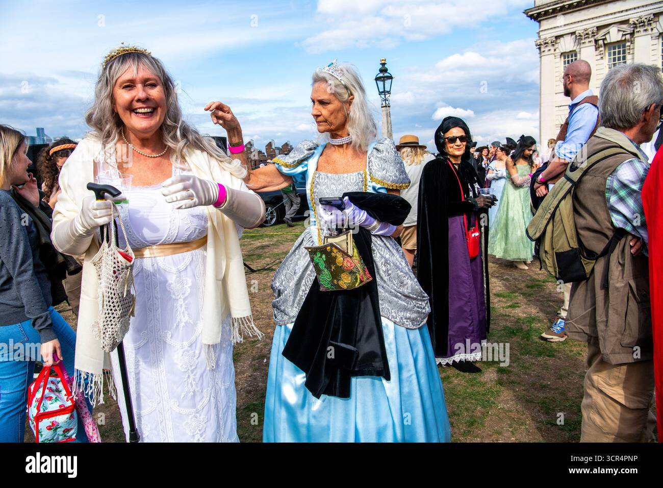 Crowds in costume gather at the Old Royal Naval College, setting a ...