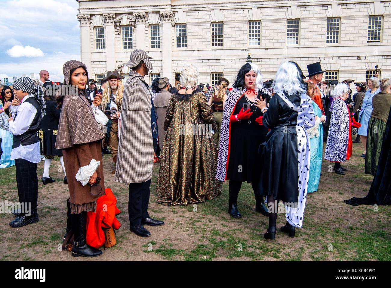 Crowds in costume gather at the Old Royal Naval College, setting a ...