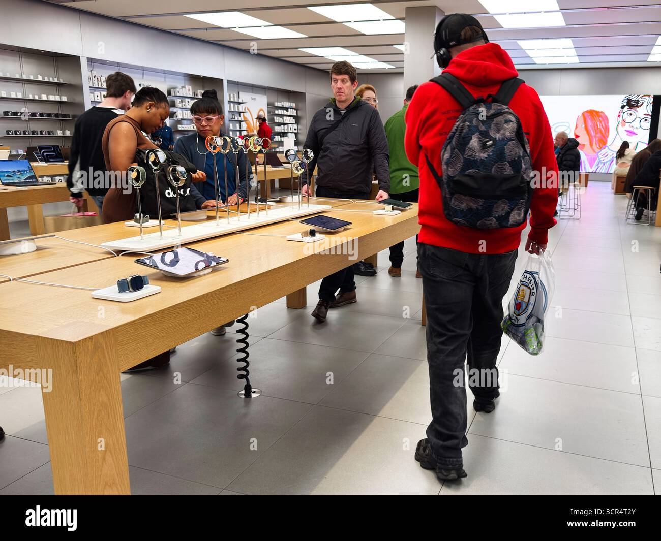 Manchester, UK - September 26, 2025: Customers browse a tech Apple ...