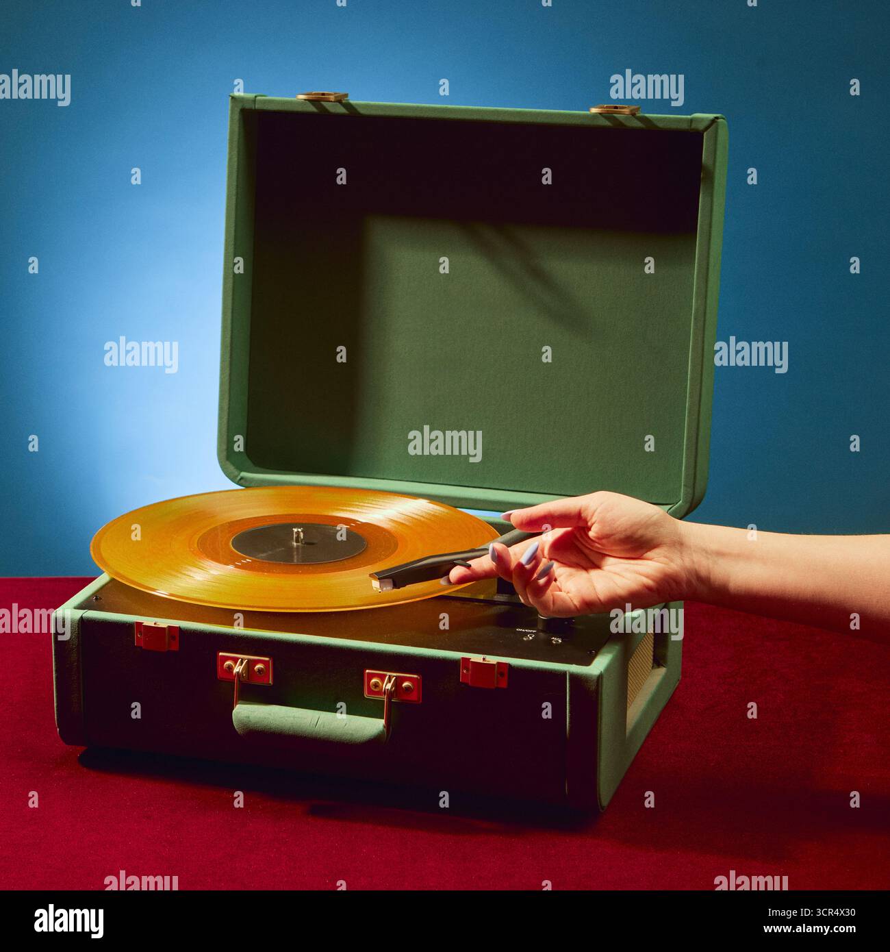 Female hand gently placing needle on golden vinyl with nostalgic ...