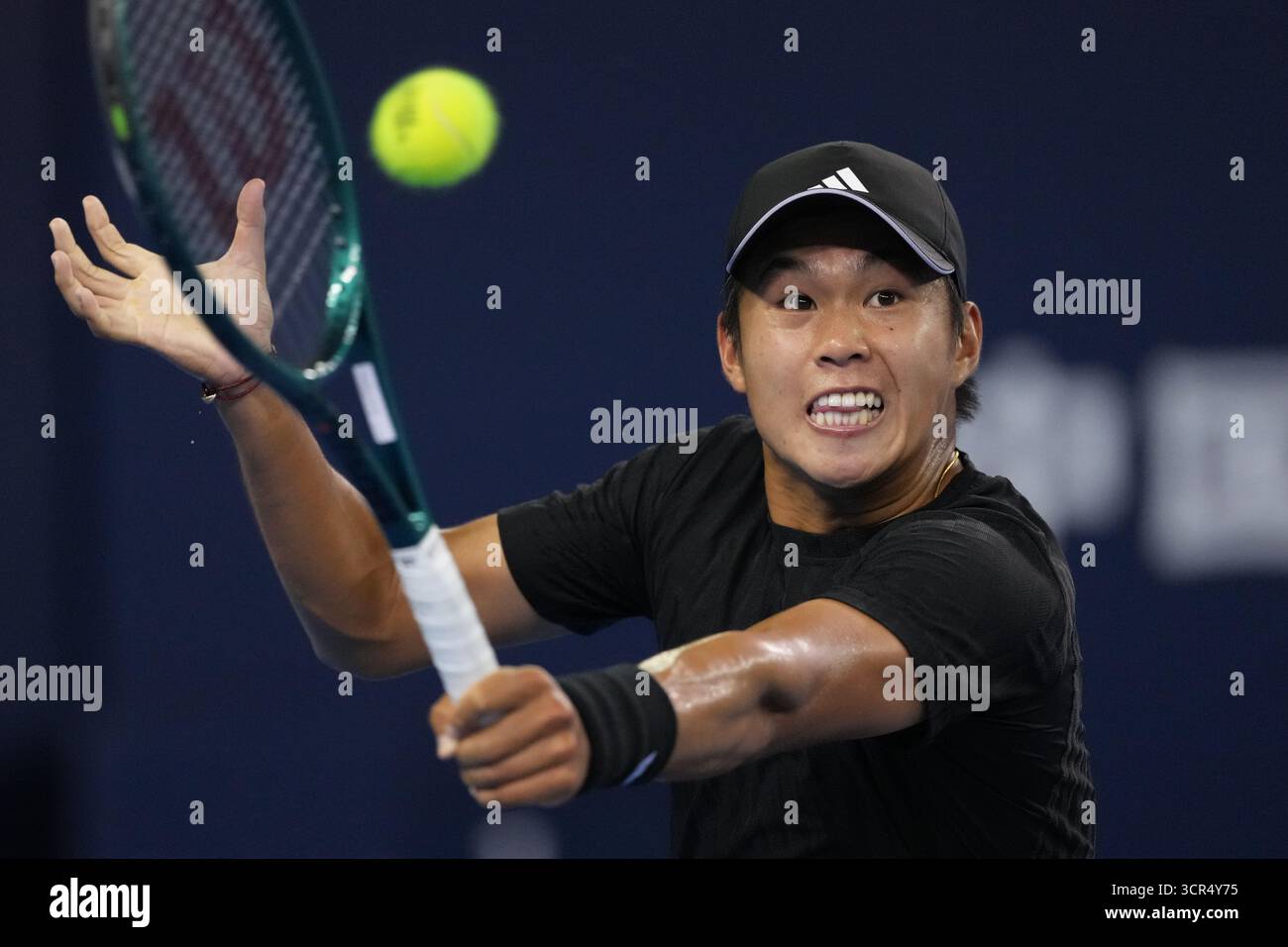 Learner Tien, of the United States plays a backhand return to Lorenzo ...