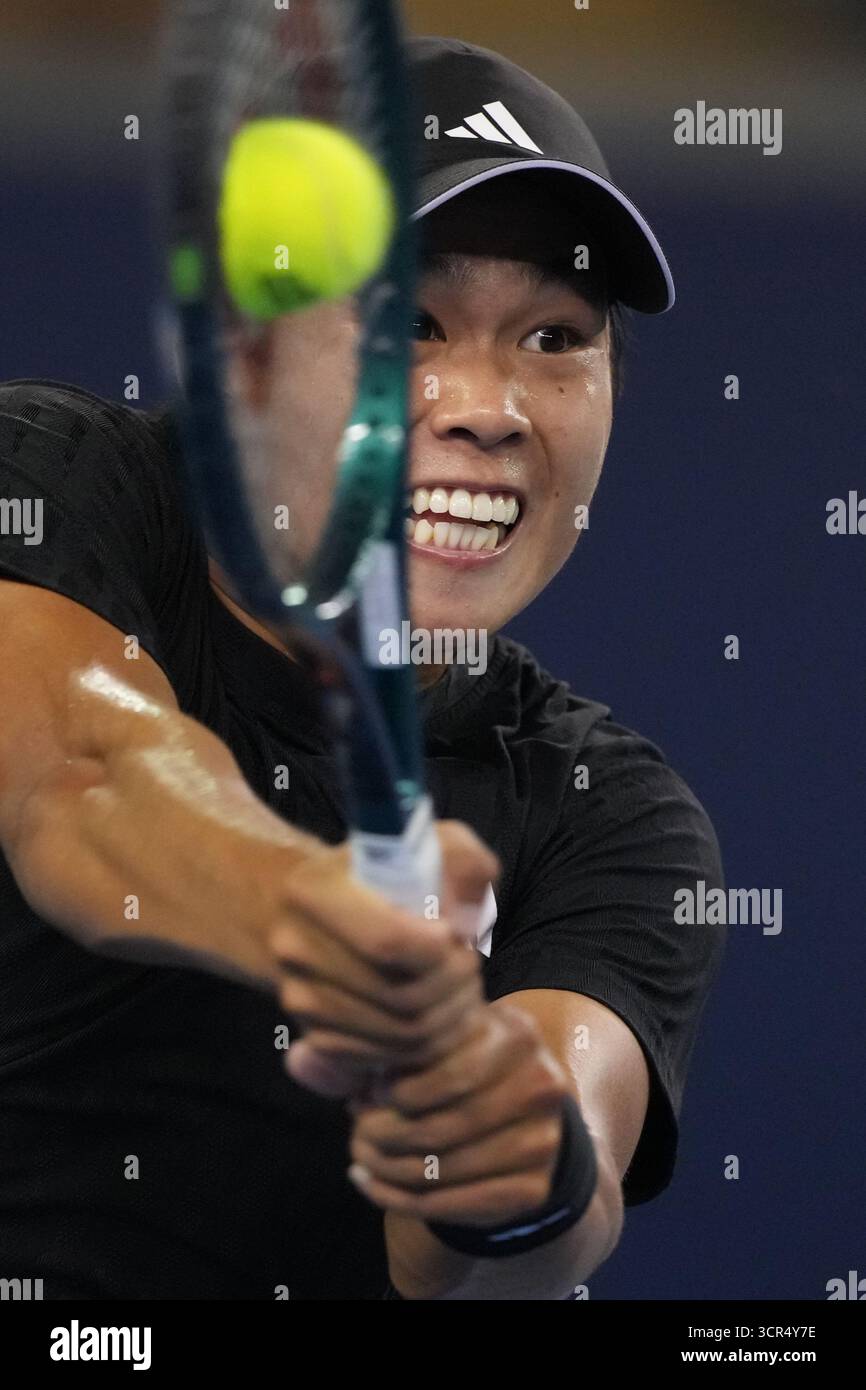 Learner Tien, of the United States plays a backhand return to Lorenzo ...