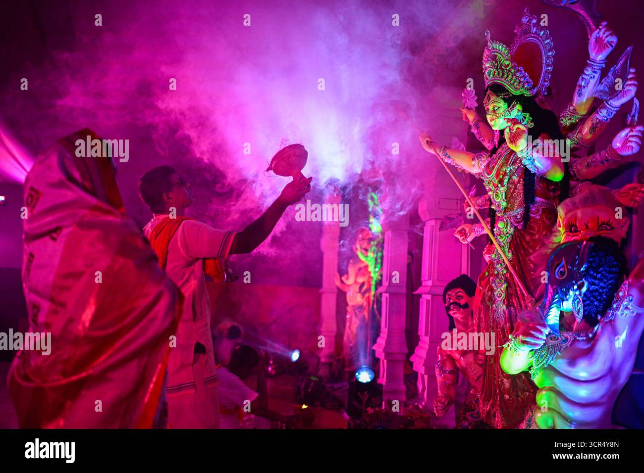 A Hindu priest performs rituals during the Durga Puja festival at a ...