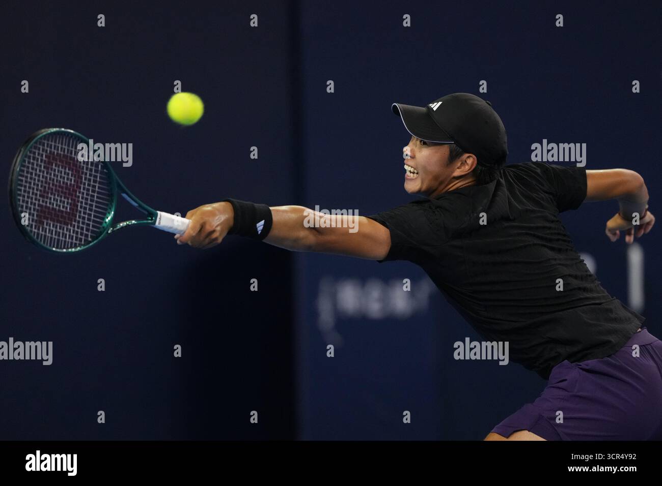 Learner Tien, of the United States plays a backhand return to Lorenzo ...
