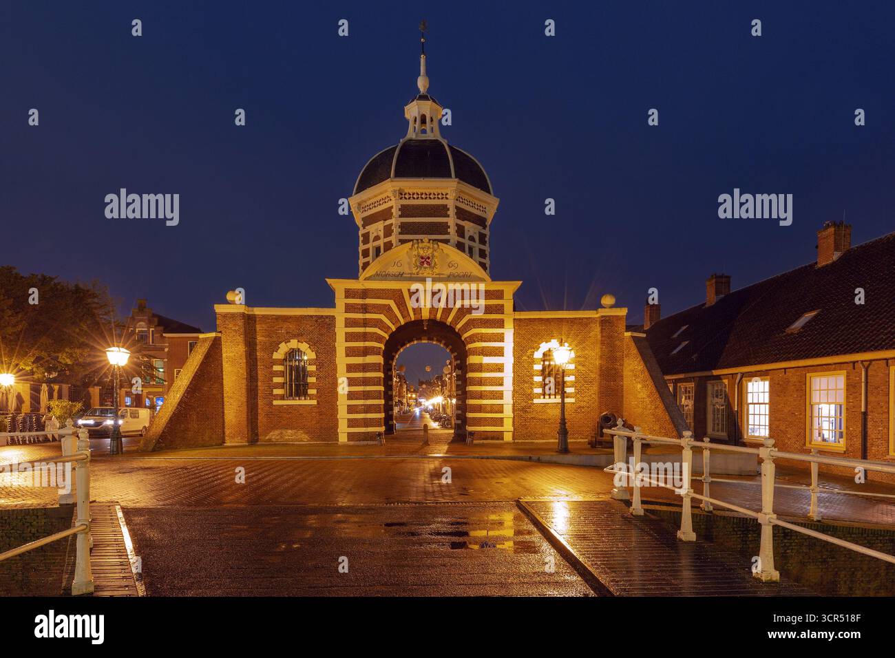 Historic Morspoort city gate illuminated at night in Leiden ...