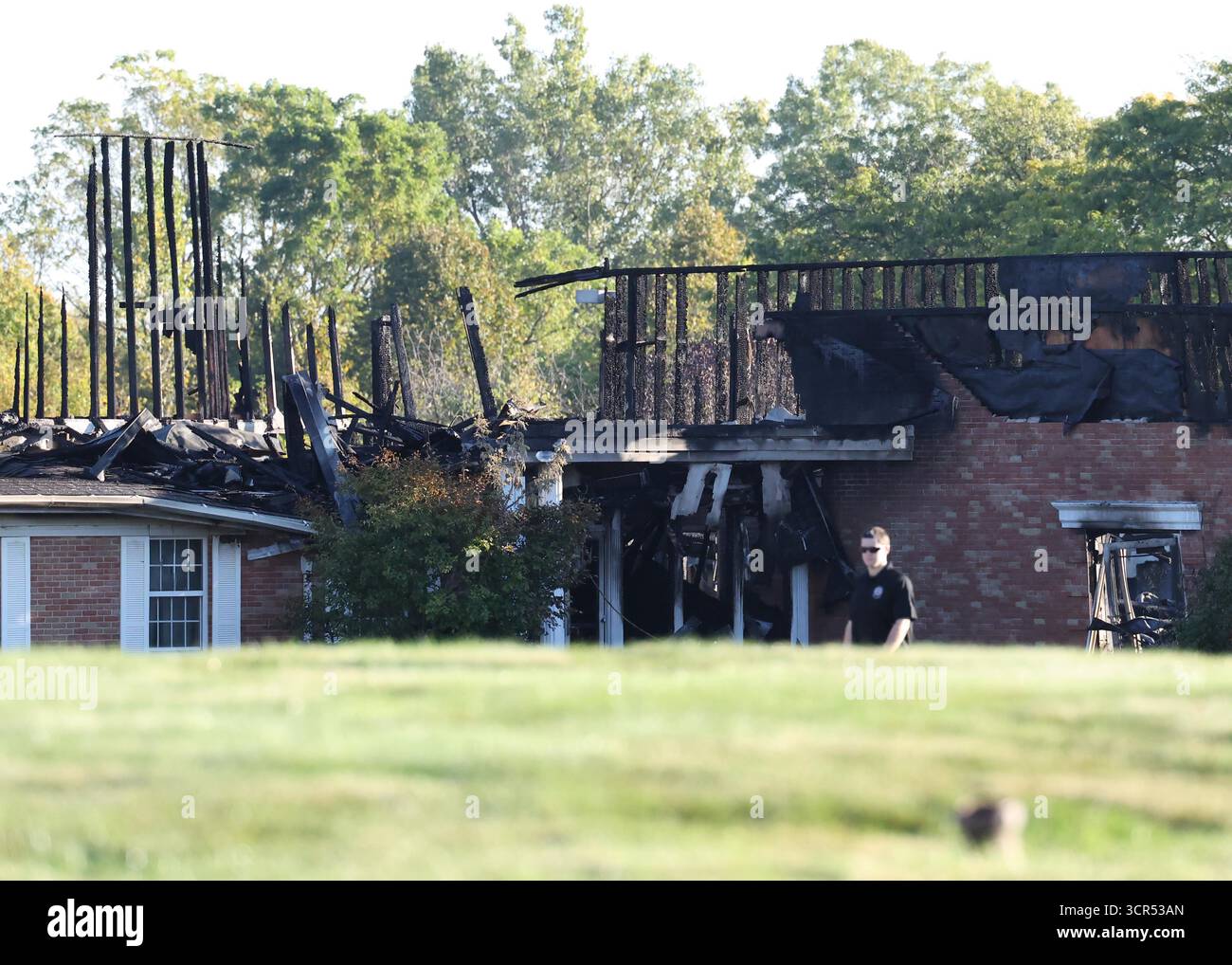 A law enforcement officer walks outside the Church of Jesus Christ of ...