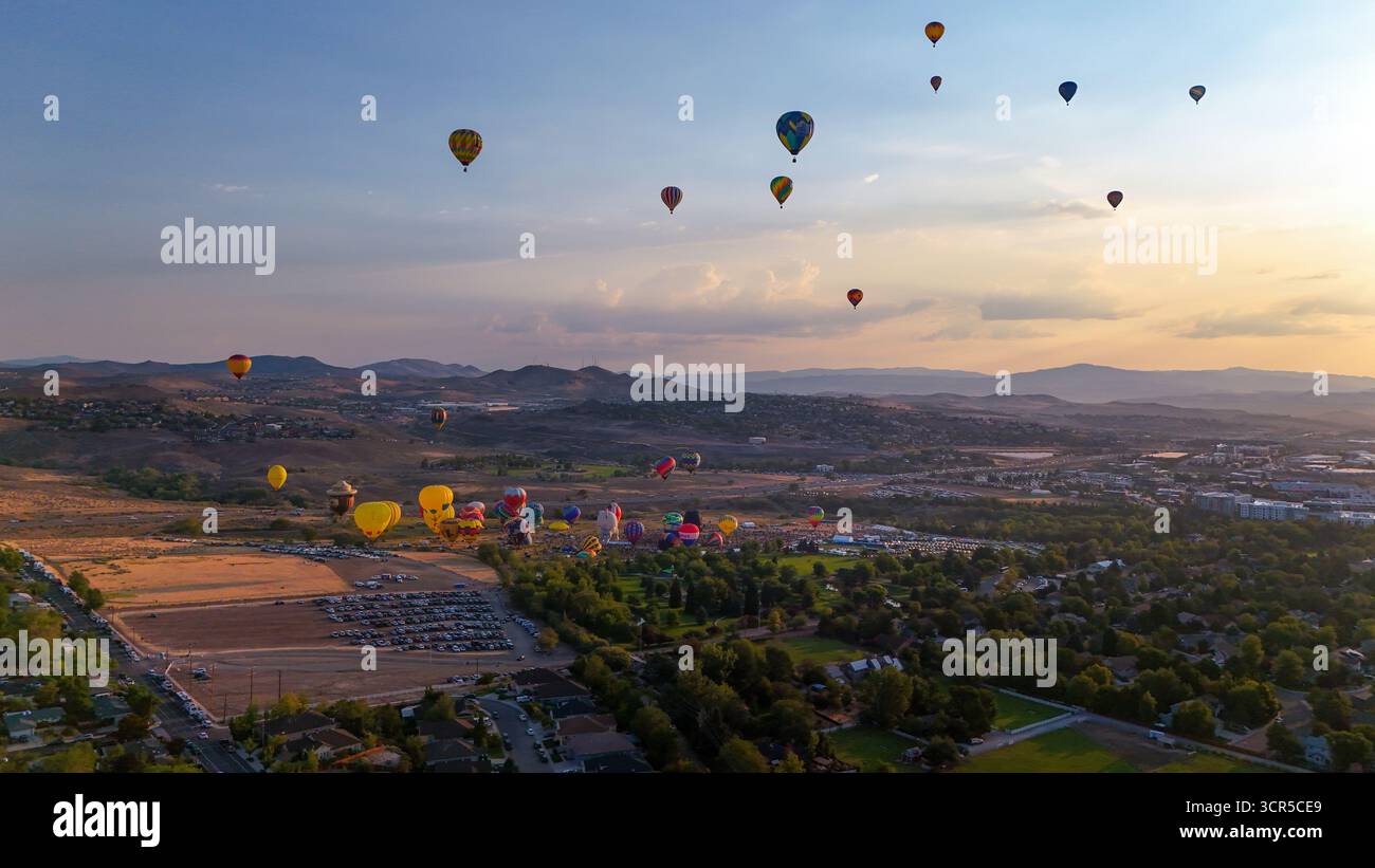 Aerial view of dozens of vibrant hot air balloons ascending against the ...