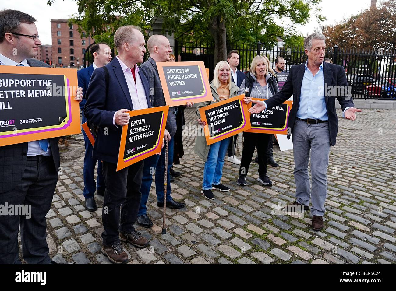 Hugh Grant (right) joins campaigners from Hacked Off and 38 Degrees ...