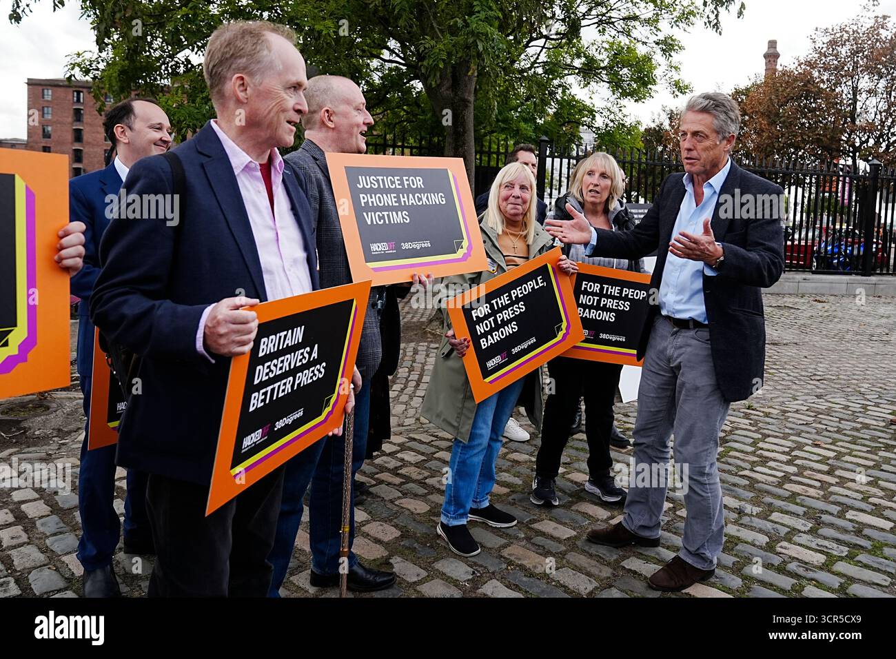 Hugh Grant (right) joins campaigners from Hacked Off and 38 Degrees ...