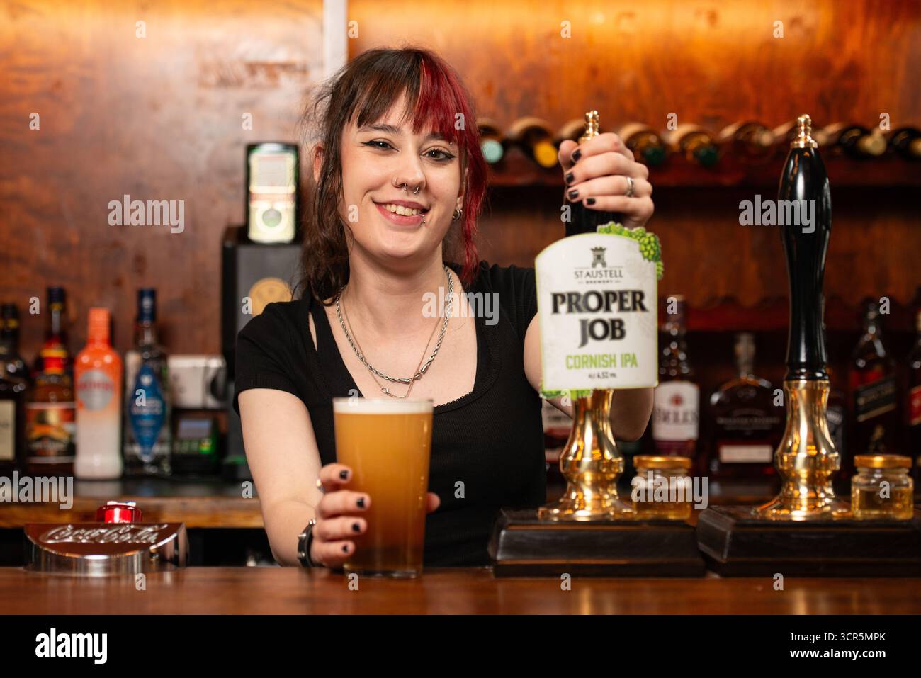 A member of bar staff at the Mother of Invention public house, city ...