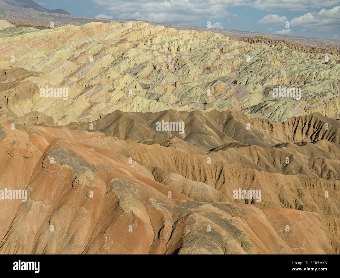 Aerial view of the undulating, multi-colored terrain of Huoyun Valley ...