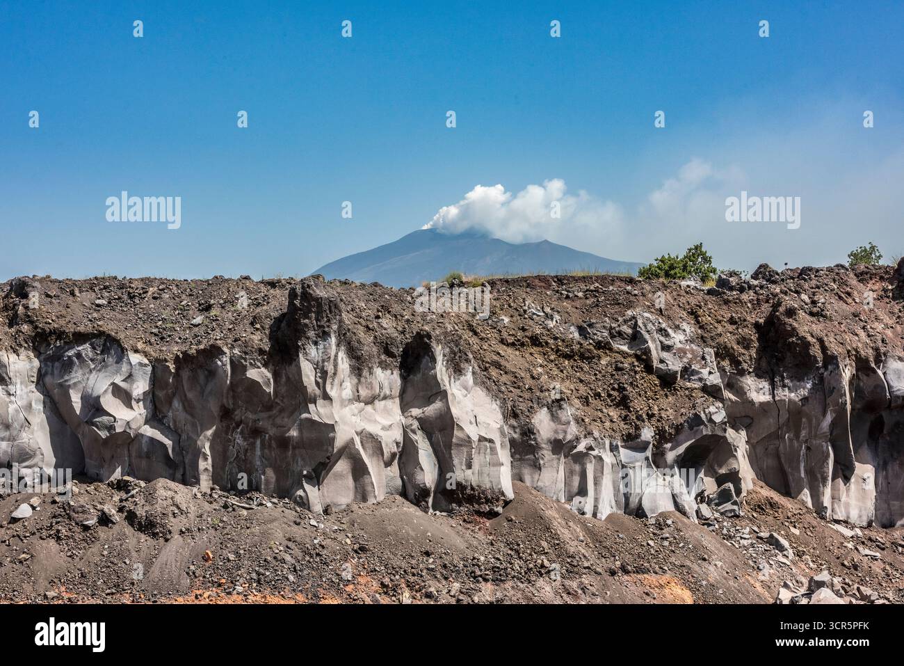 A view of Mount Etna from a basalt quarry on its flank, showing layers ...