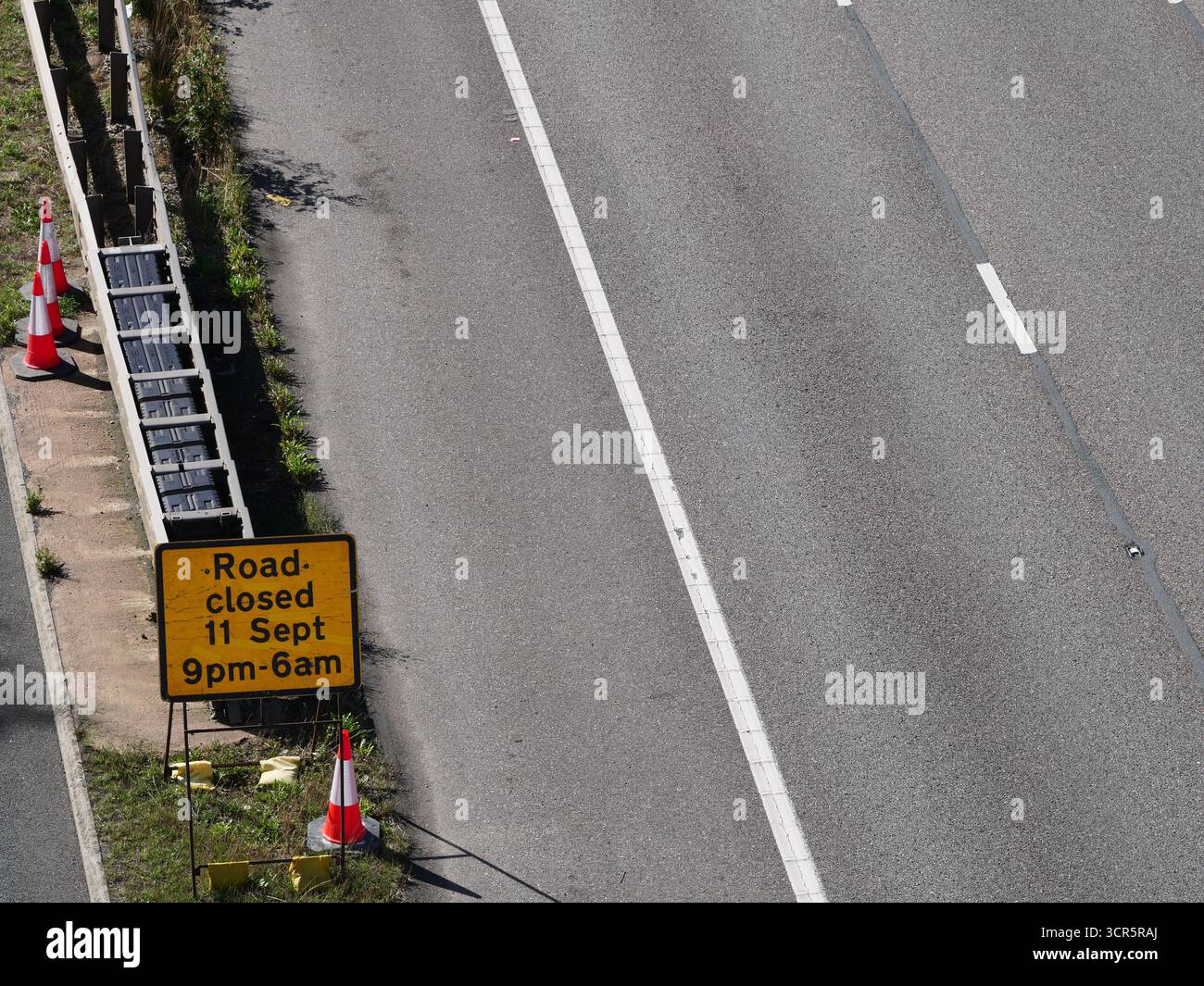 Road closure advance warning sign on the side of carriageway, overhead ...
